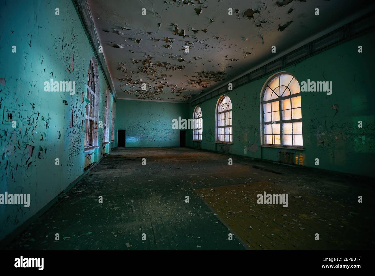 Large empty hall inside old abandoned building Stock Photo - Alamy