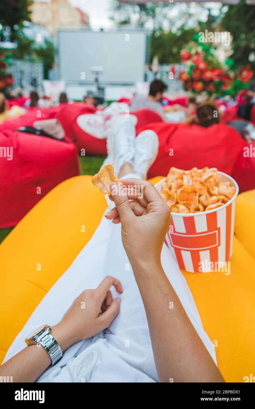 laying eating snacks watching movie at open air cinema Stock Photo - Alamy