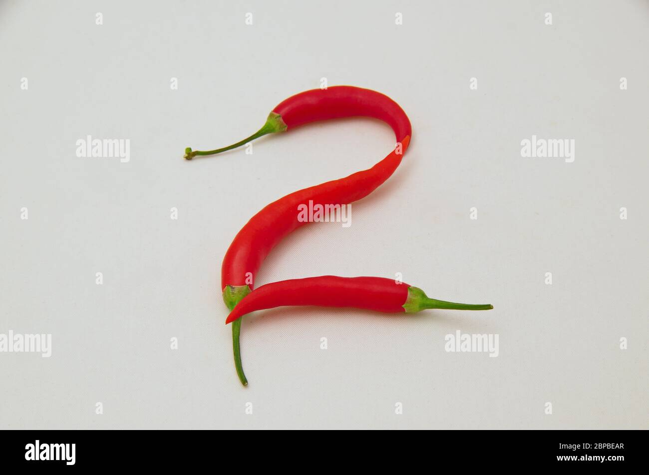 Sign 2, made from the fruit of fresh chilli red pepper with a green ...