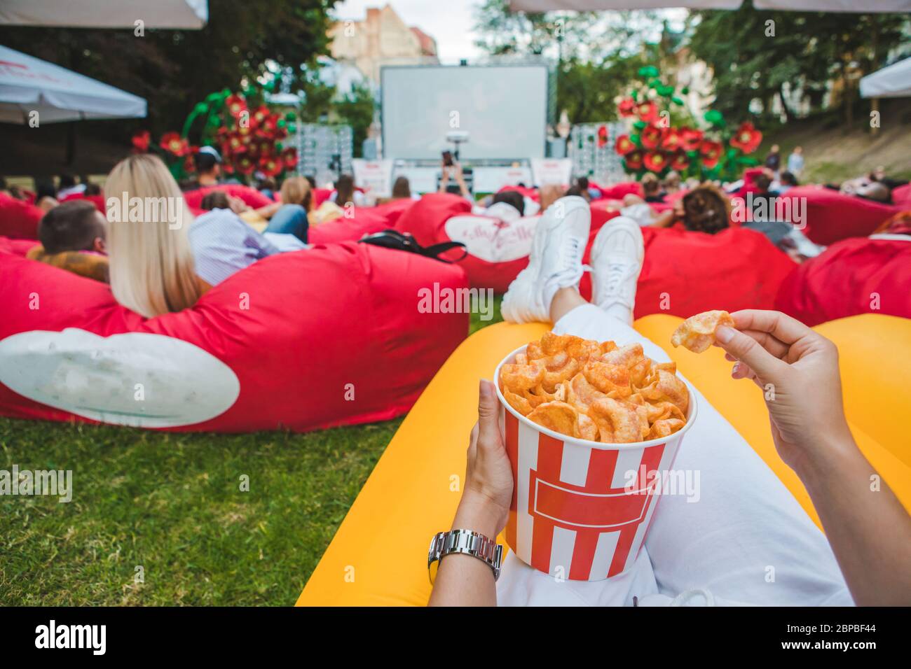 laying eating snacks watching movie at open air cinema Stock Photo - Alamy