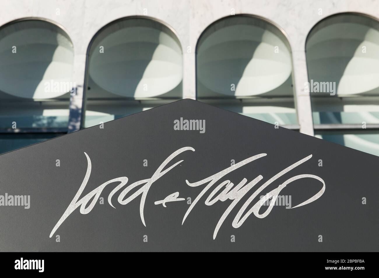 A logo sign outside of a Lord & Taylor retail store location in ...