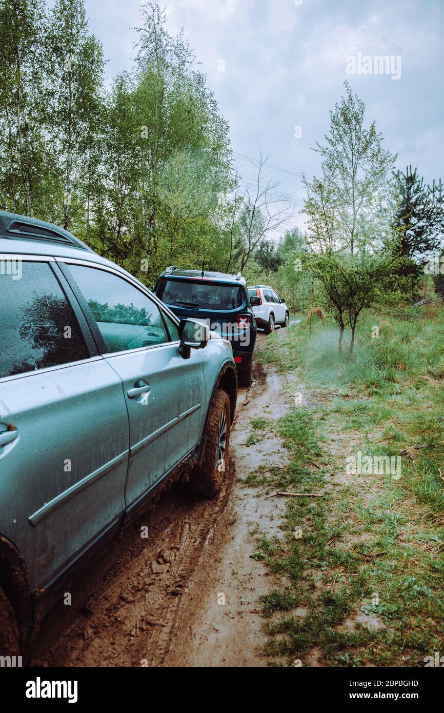 three suv cars at mud off road trail in forest Stock Photo - Alamy