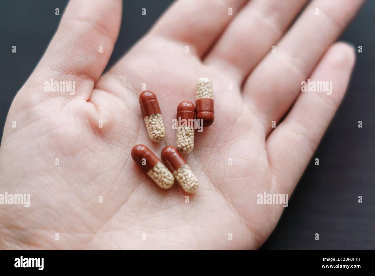 medicine transparent capsules in woman hand Stock Photo - Alamy