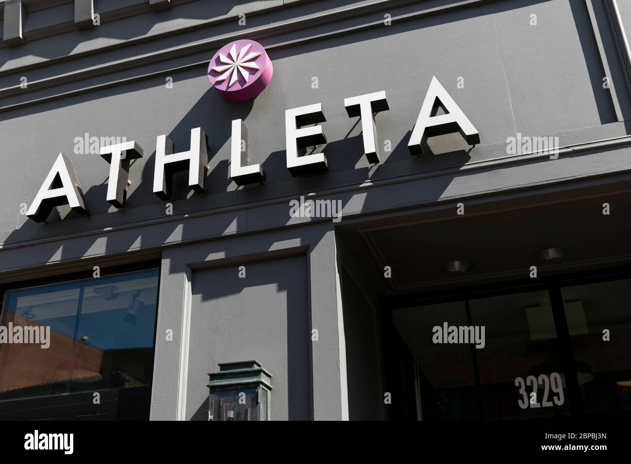 A logo sign outside of a Athleta retail store location in Washington, D ...