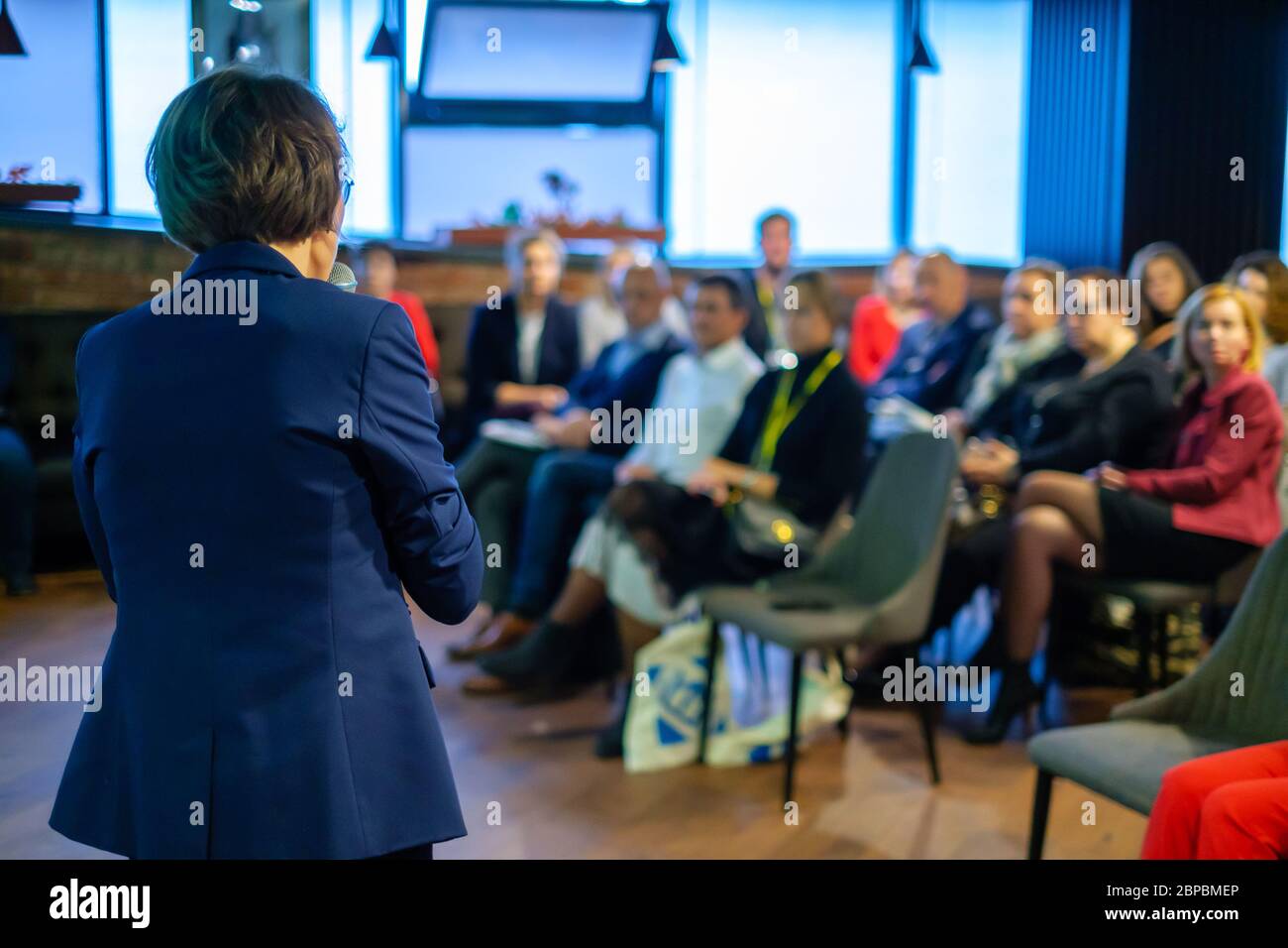 Female presenter speaks to audiences Stock Photo - Alamy
