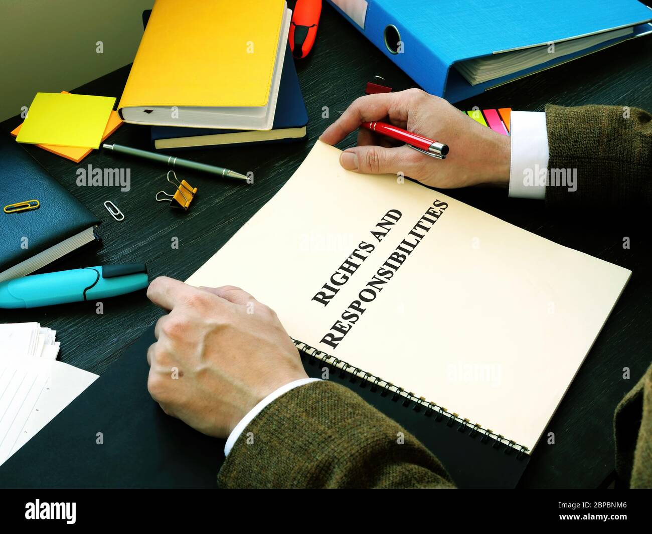 Manager reads Employee rights and responsibilities list book Stock ...