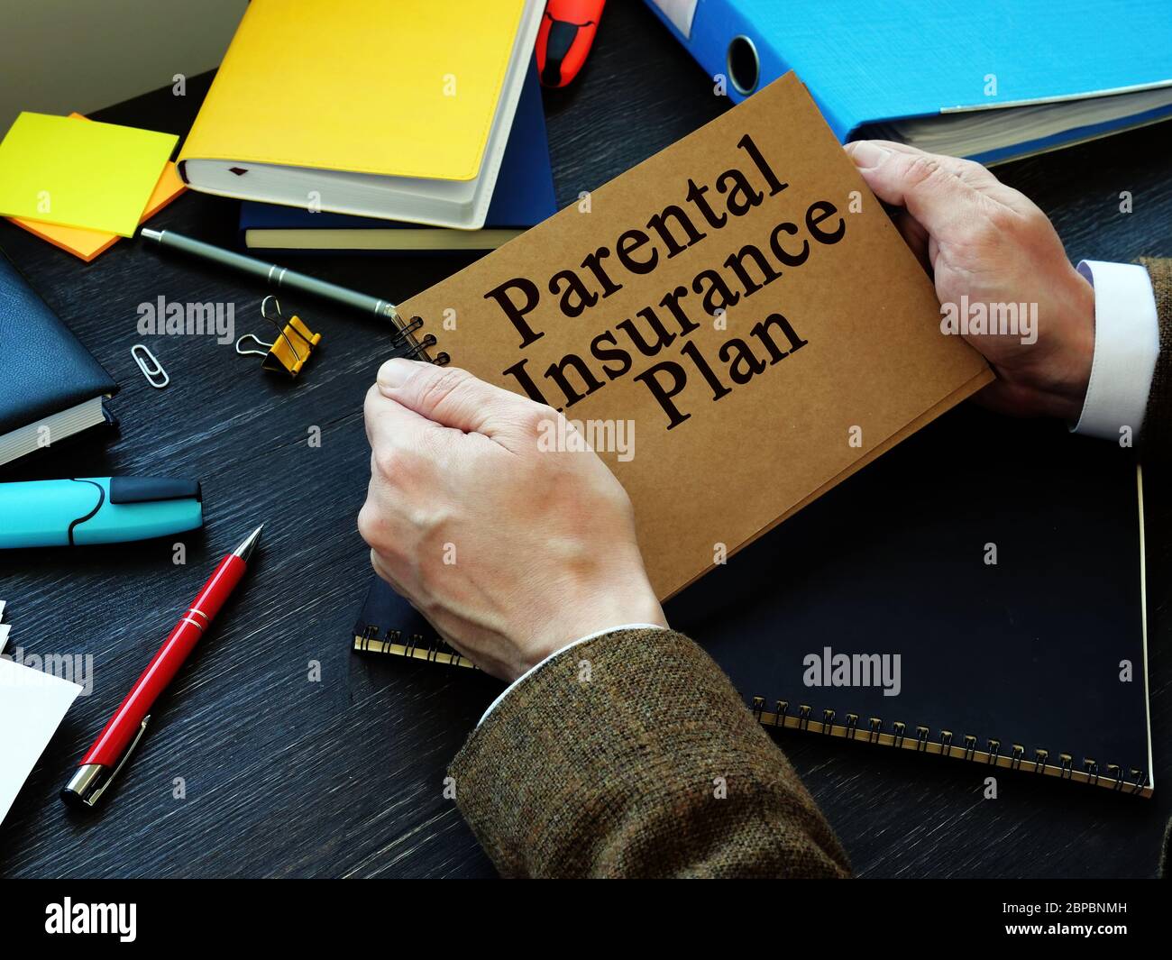 Man reads about Provincial Parental Insurance Plan PPIP Stock Photo - Alamy