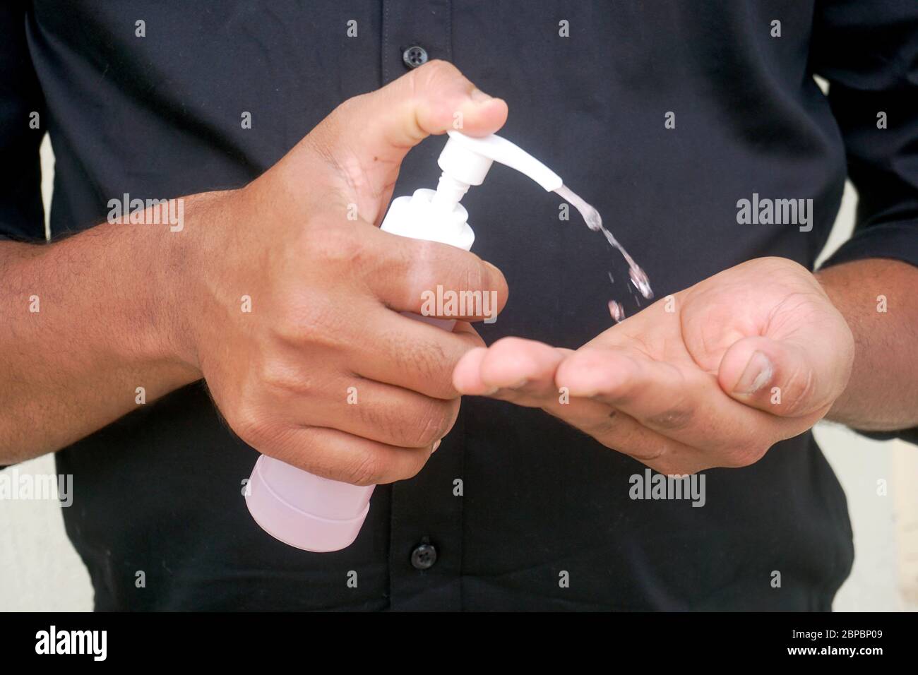Man using wash hand sanitizer hi-res stock photography and images - Alamy