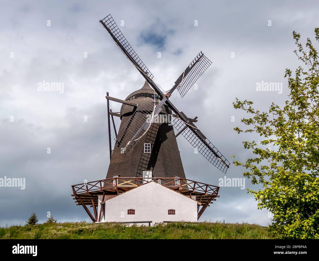 The historic Baunhoj Mill in Grenaa, Denmark. Old mill in black and ...