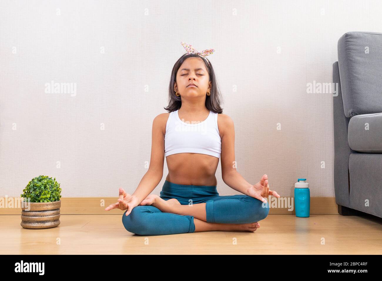 Teen girl doing yoga at home Stock Photo - Alamy