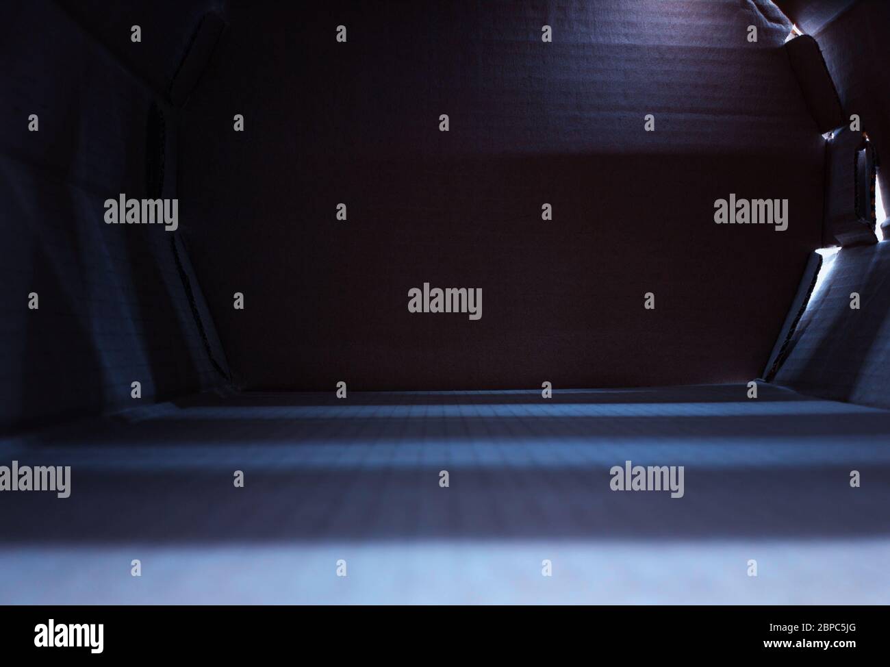 Dramatic light rays inside toy cardboard box Stock Photo - Alamy