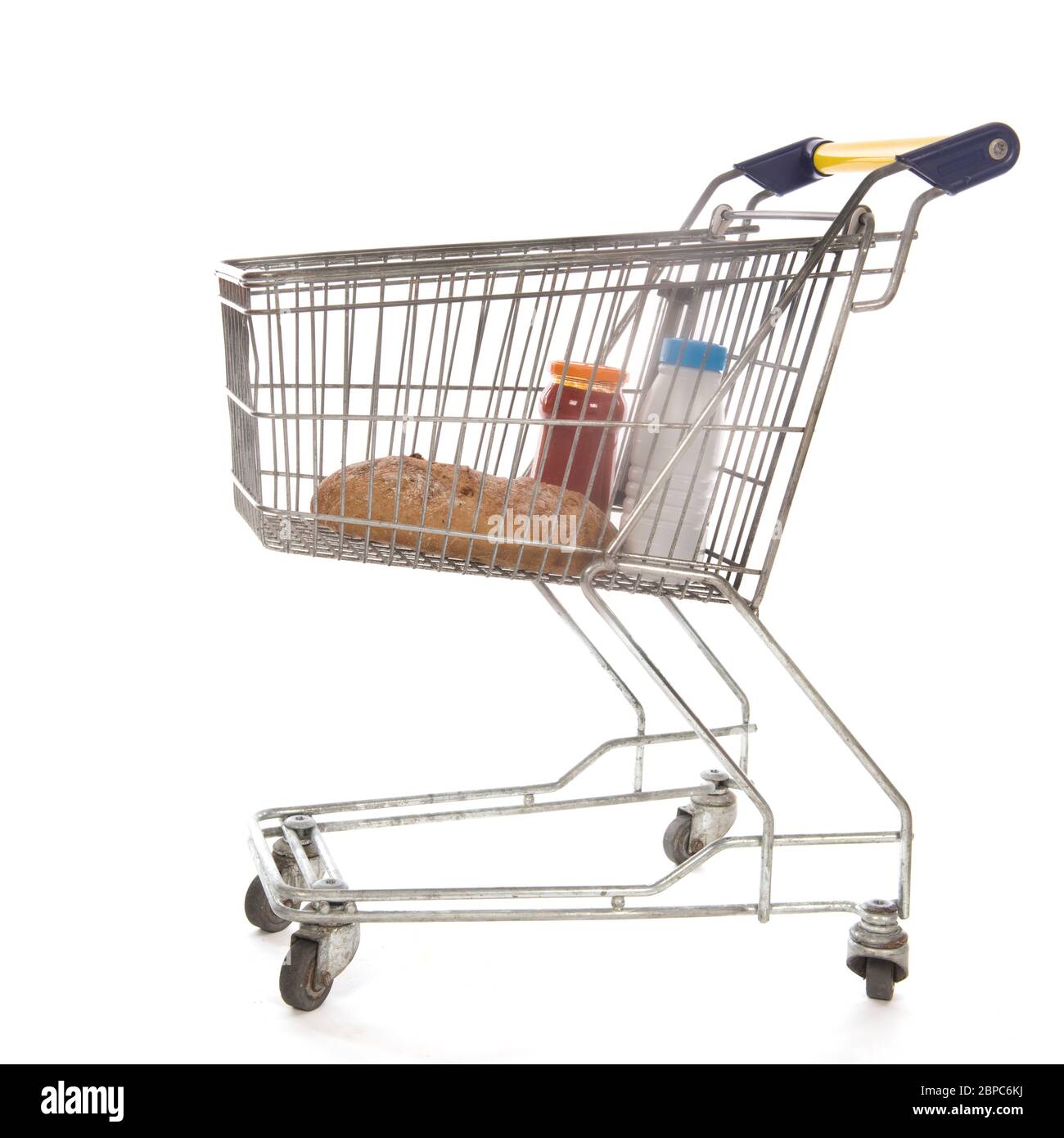 Shopping cart blue and yellow full with fresh groceries Stock Photo - Alamy