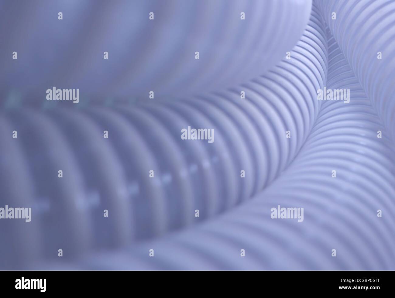Curved crimped white tubes background Stock Photo - Alamy