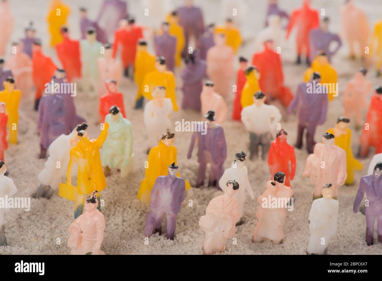 People crowd standing in sand Stock Photo - Alamy