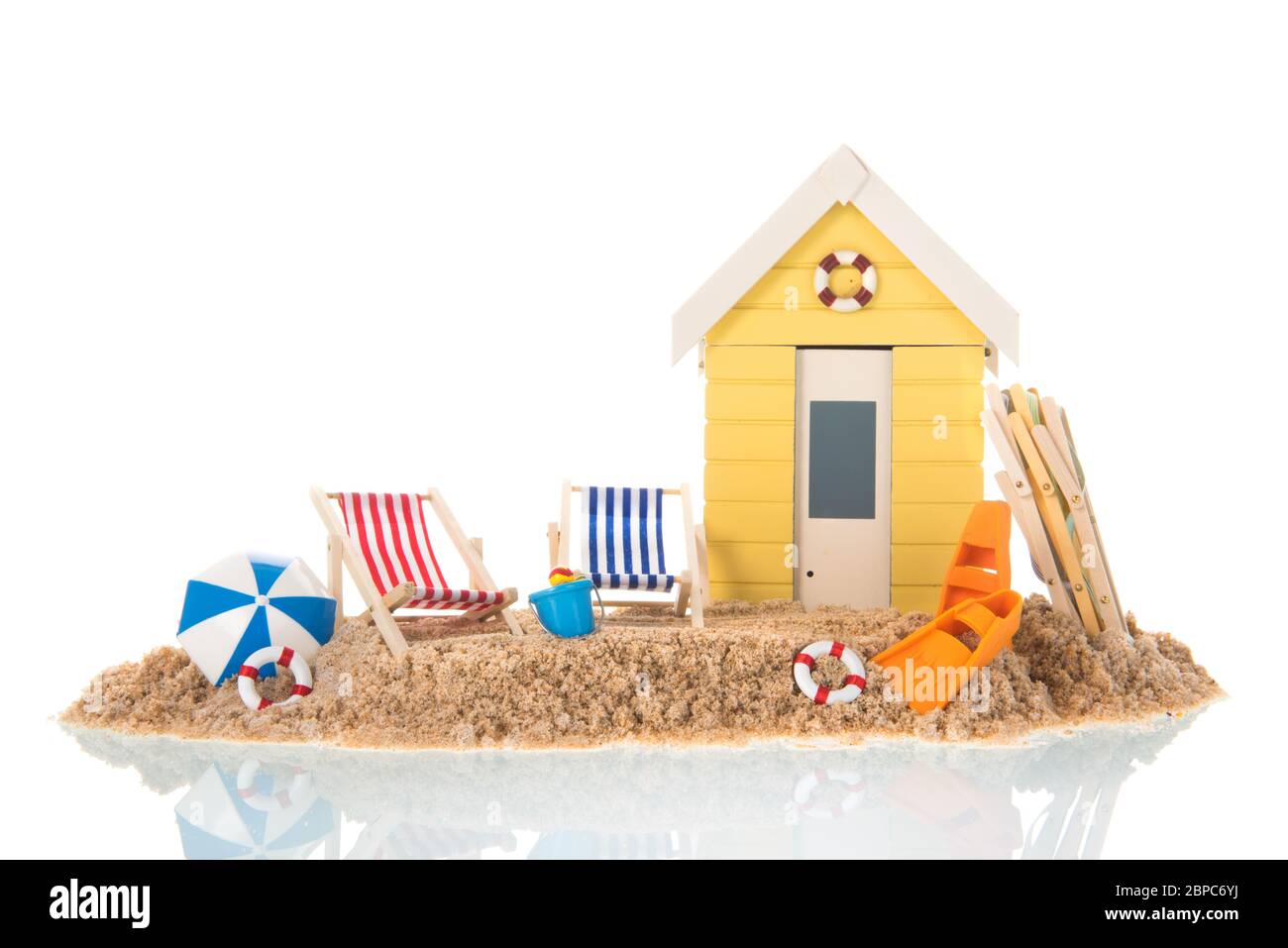 Beach chairs and yellow hut in sand isolated over white background ...