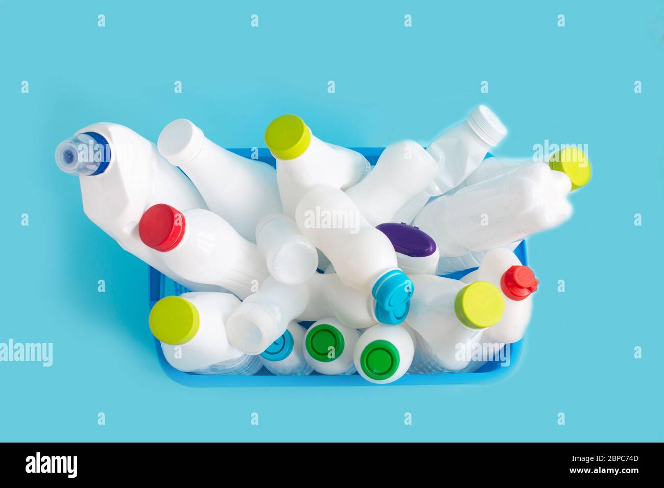 Empty Used white plastic bottles in basket for recyclable waste ...