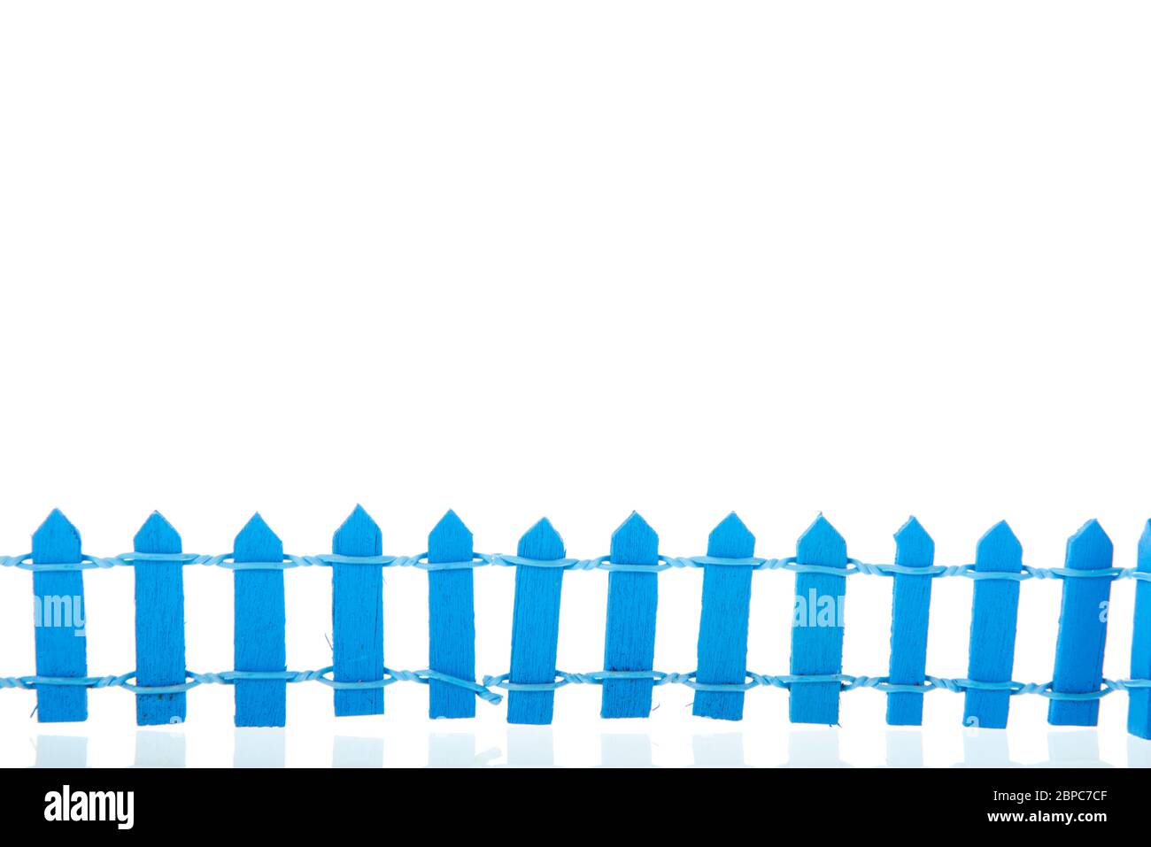 Miniature blue fence isolated over white background Stock Photo - Alamy