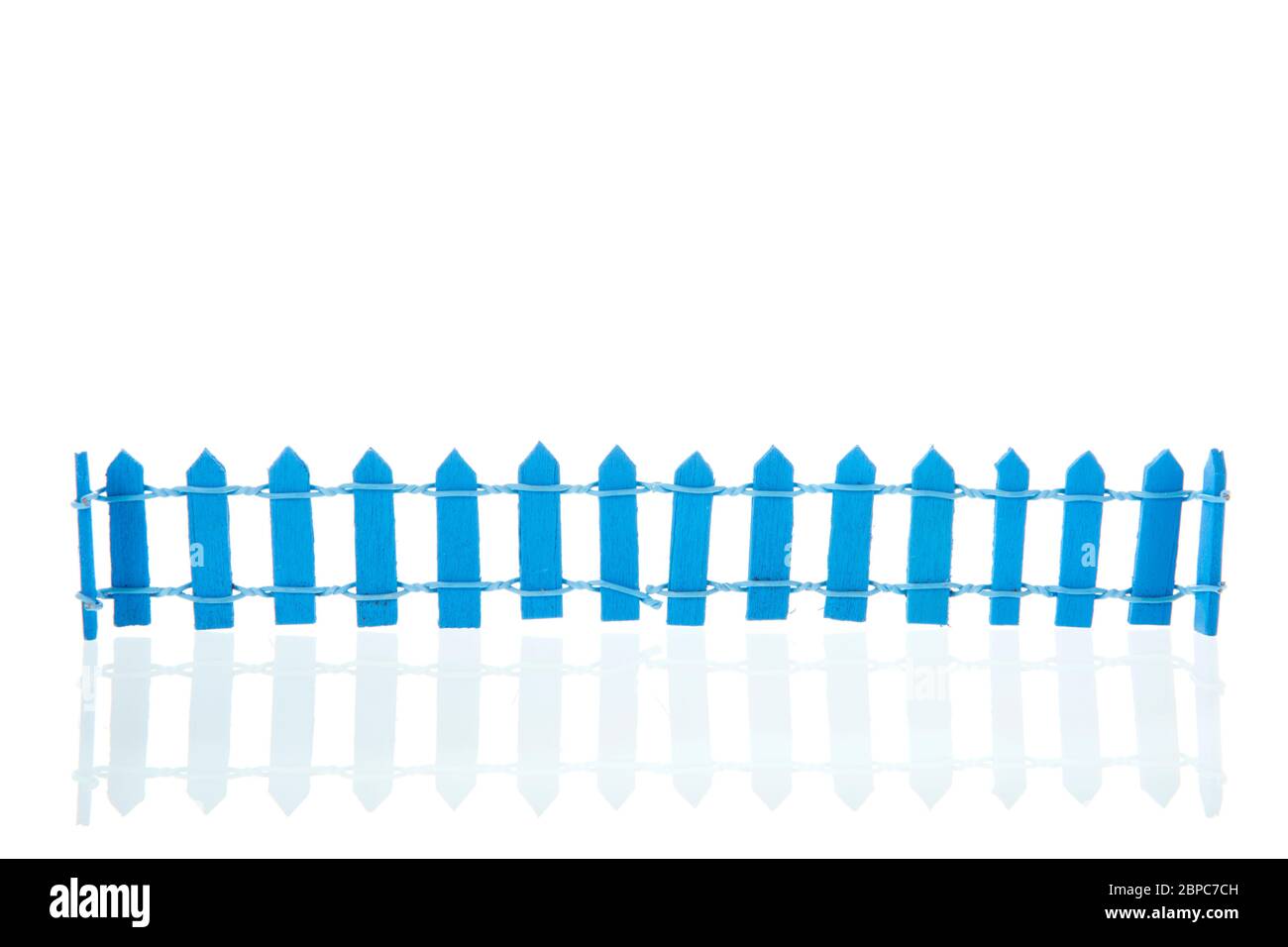 Miniature blue fence isolated over white background Stock Photo - Alamy