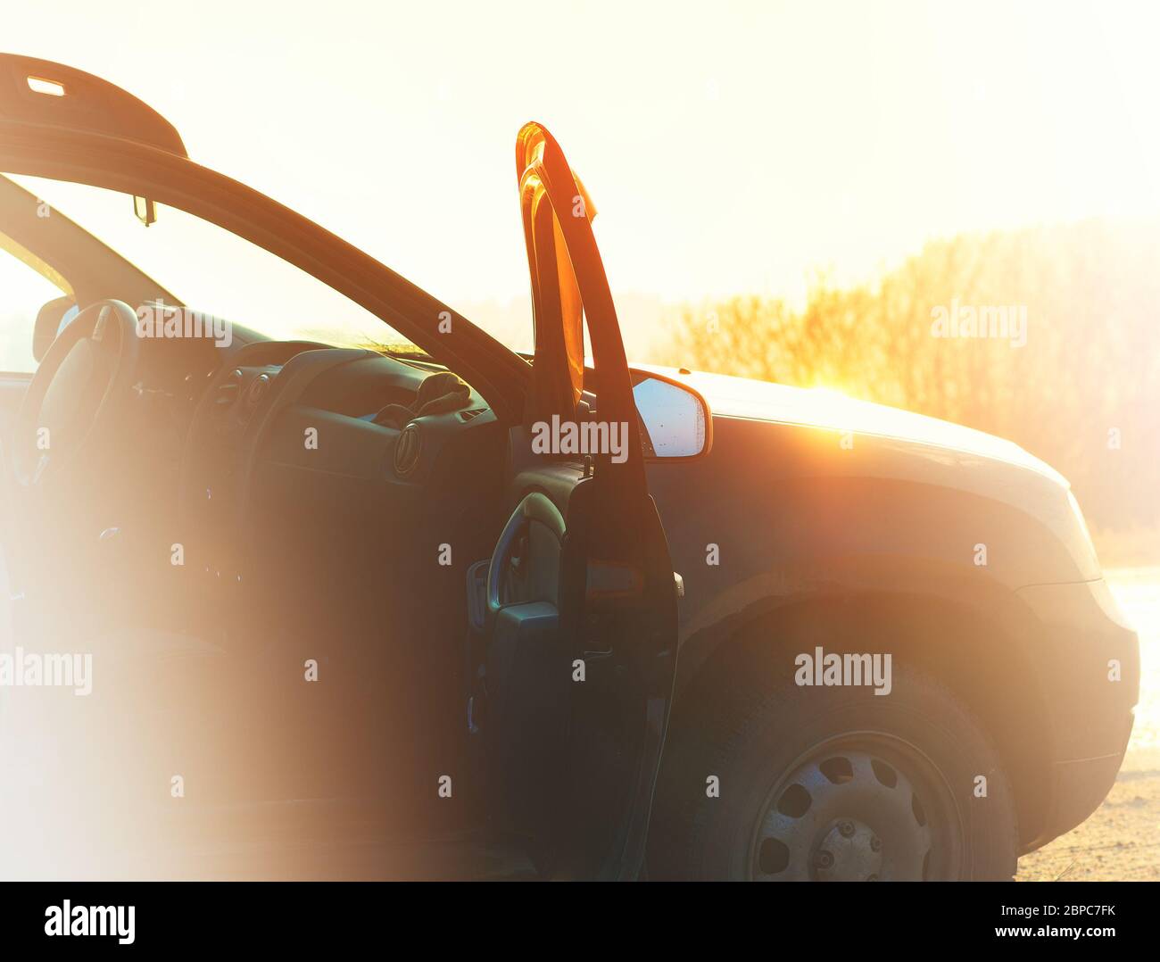 Car with opened door during sunset background Stock Photo - Alamy