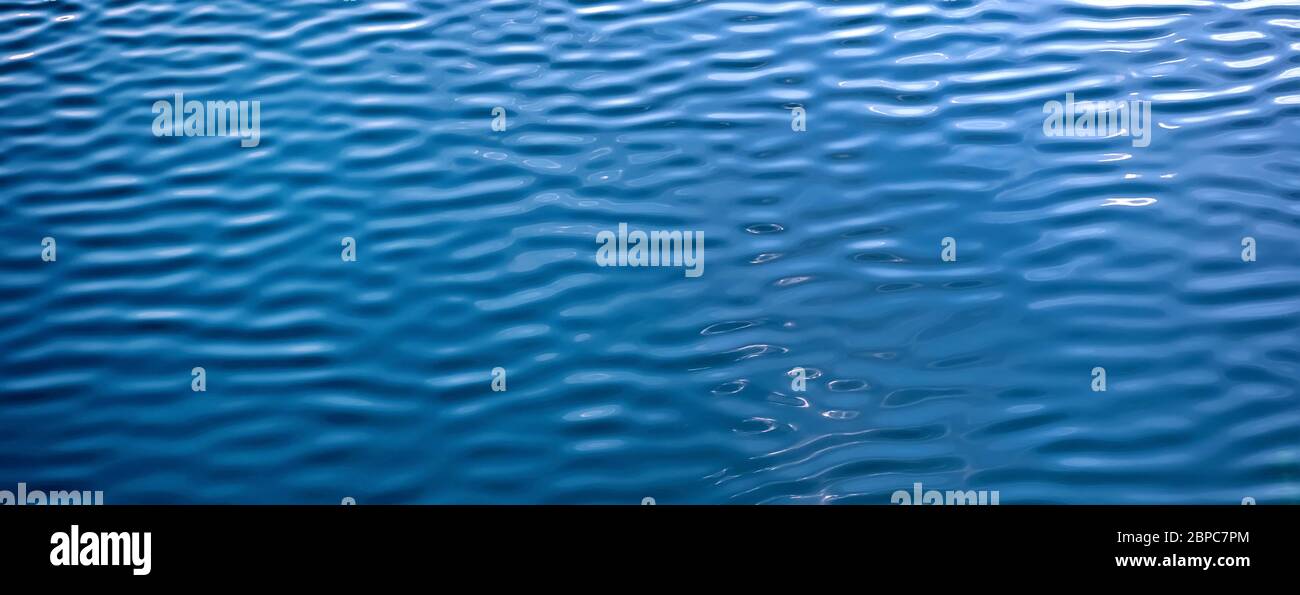 Water Waves Surface as Background. Light ripples in the water ...