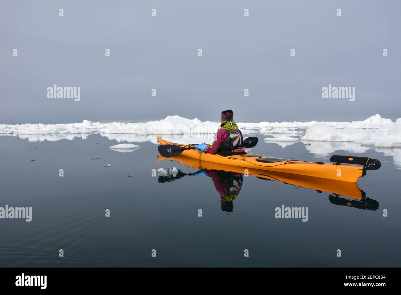 Kayaking amid floating sea ice in Svalbard, Arctic Norway, in summer ...