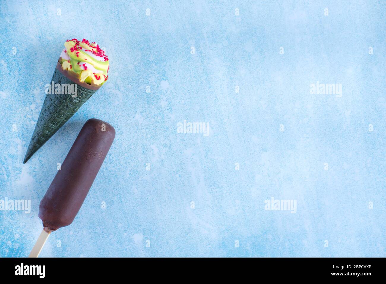 Ice cream in chocolate, ice cream cone with green waffle and bright ...