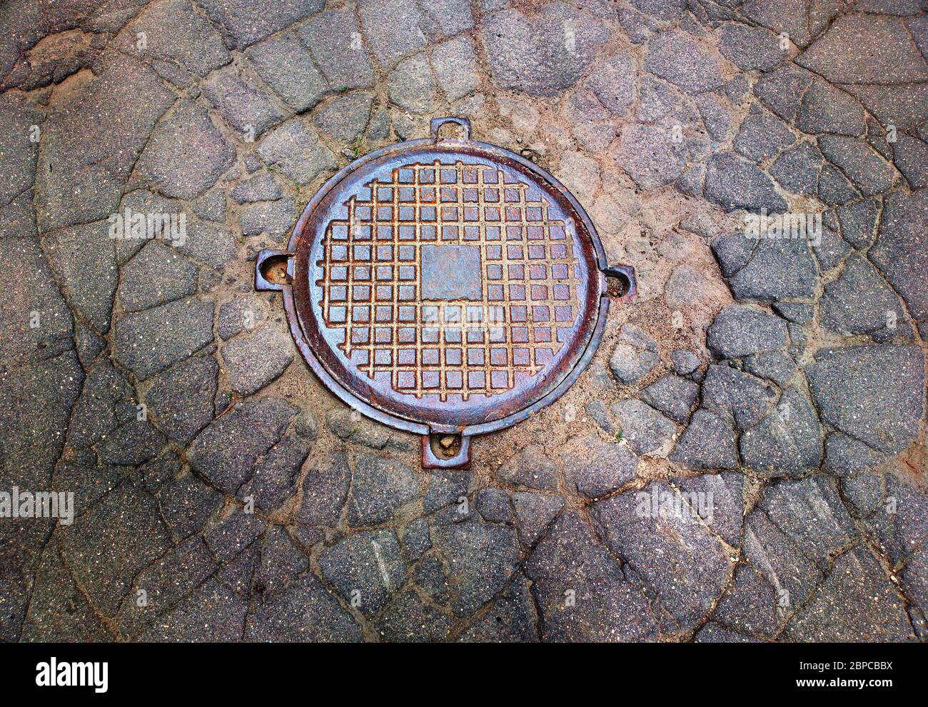 Vintage hatch on the city road background Stock Photo - Alamy