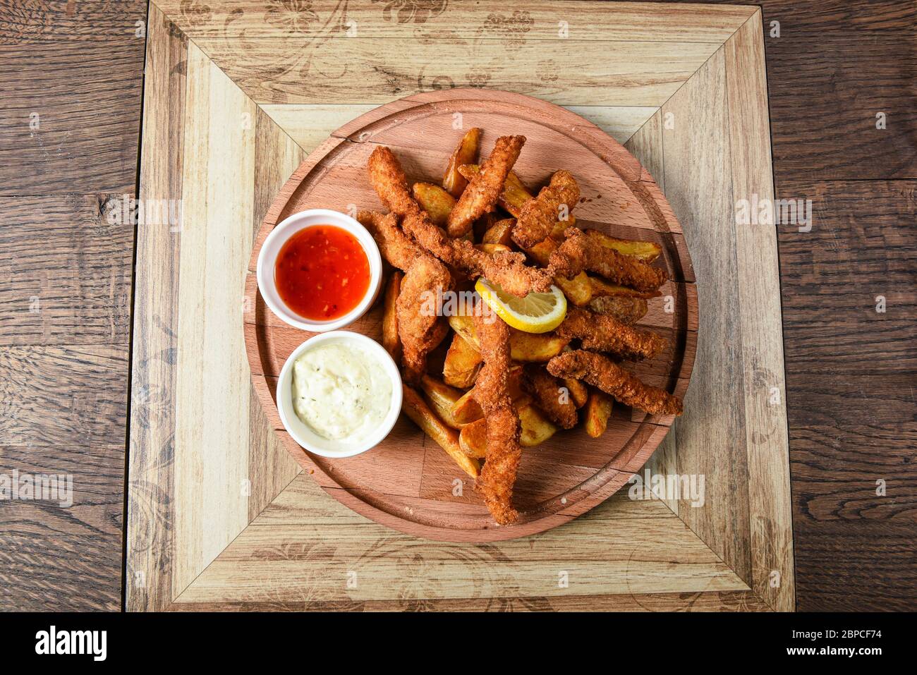 Crispy chicken and potatoes fried with spices Stock Photo - Alamy