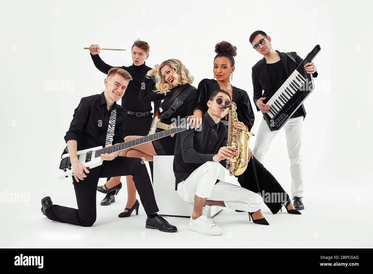 photo of multi ethnic music band in studio.Musicians and woman soloist ...