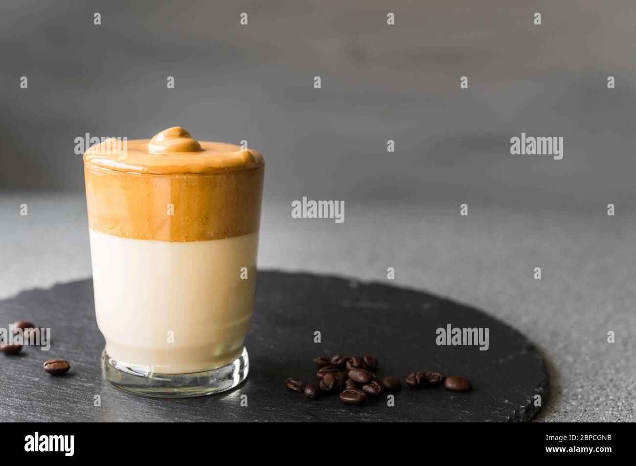 Dalgona coffee whipped cream mousse against grey background Stock Photo ...