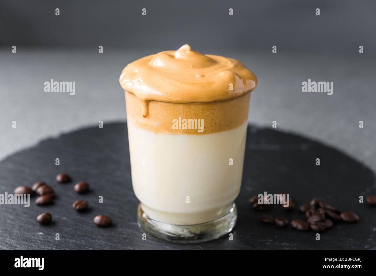 Dalgona coffee whipped cream mousse against grey background Stock Photo ...