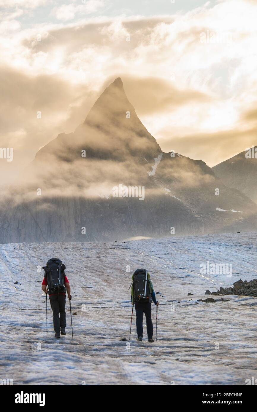 Two climbers en route to climb Mount Loki, Baffin Island Stock Photo ...