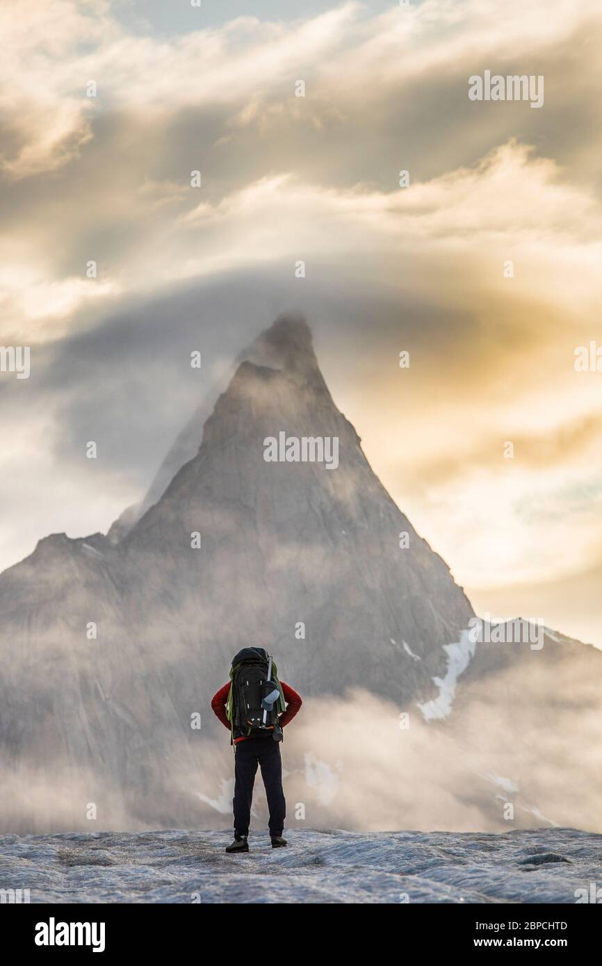 Climber standing in front of Mt. Loki, Baffin Island, Canada Stock ...