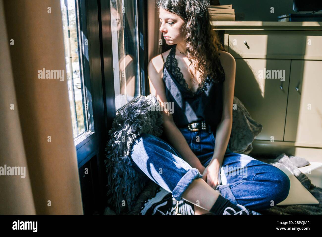 young girl looking by the window Stock Photo - Alamy