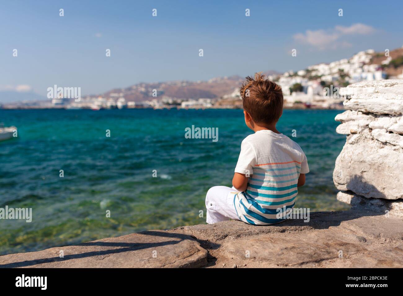 Little boy looking over Mykonos, Greece Stock Photo - Alamy