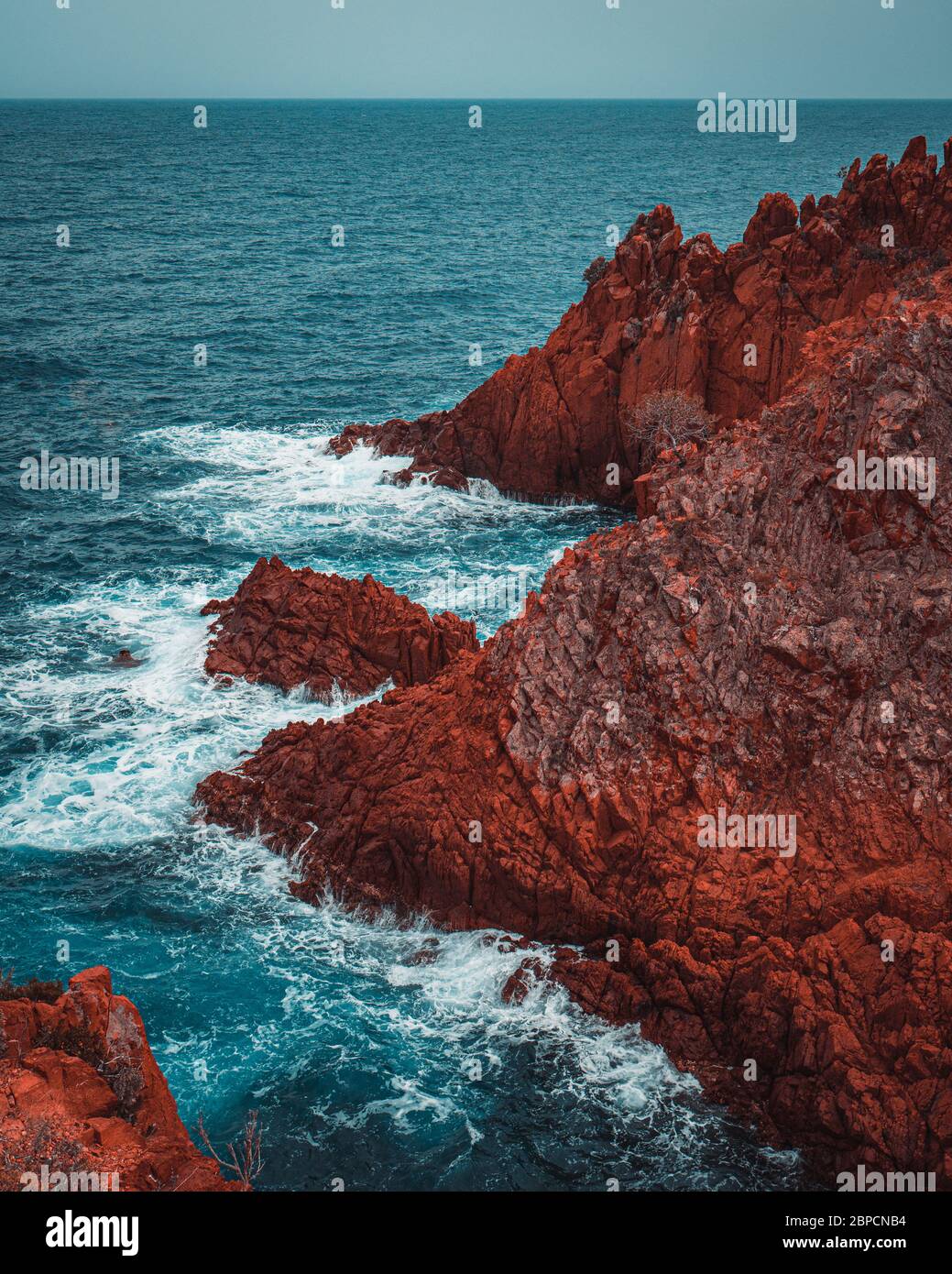 Tall orange cliffs and blue sea at French Riviera, France Stock Photo ...