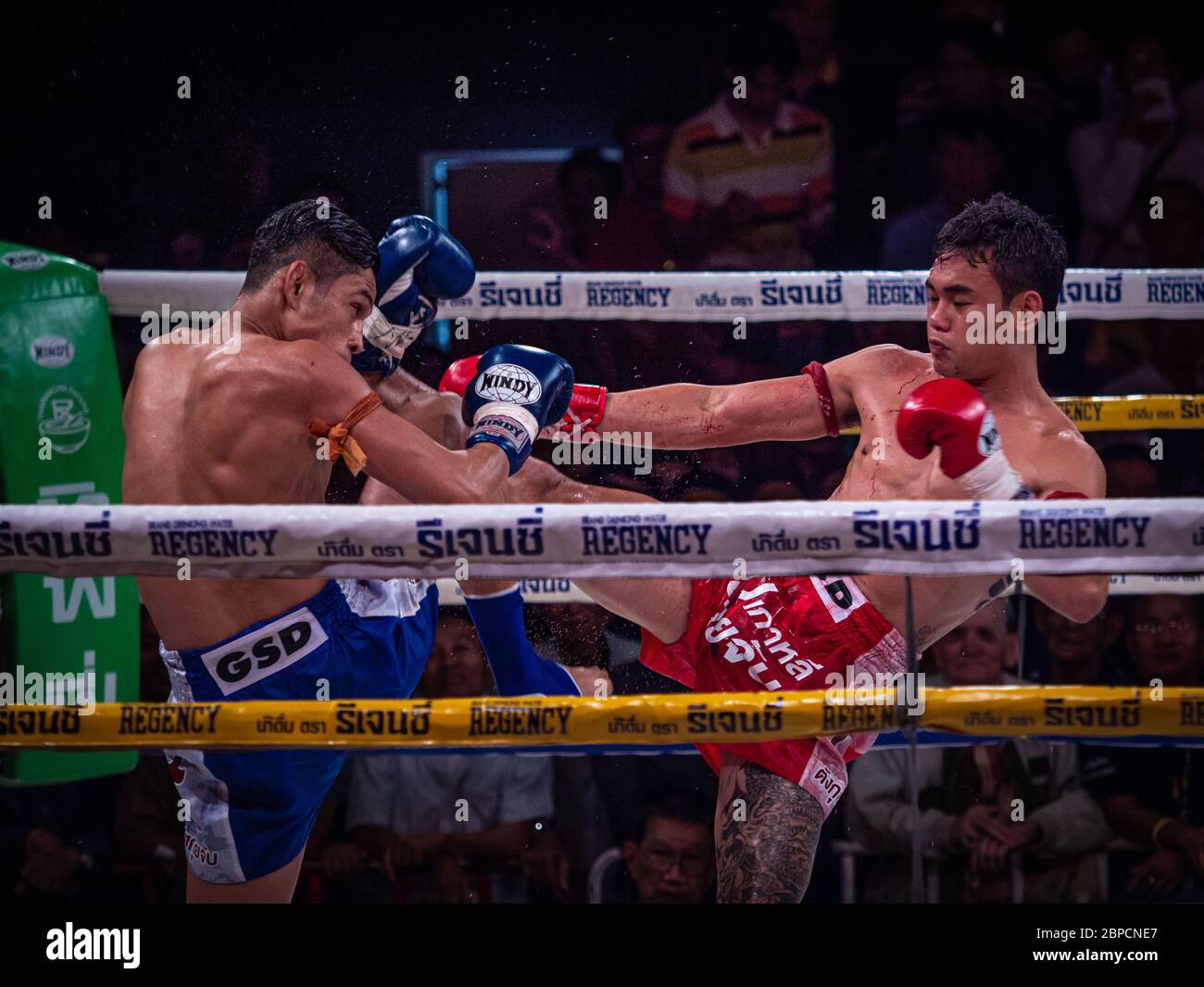 Asian muay thai fighter receiving kick jab to stomach, ribs at Channel ...