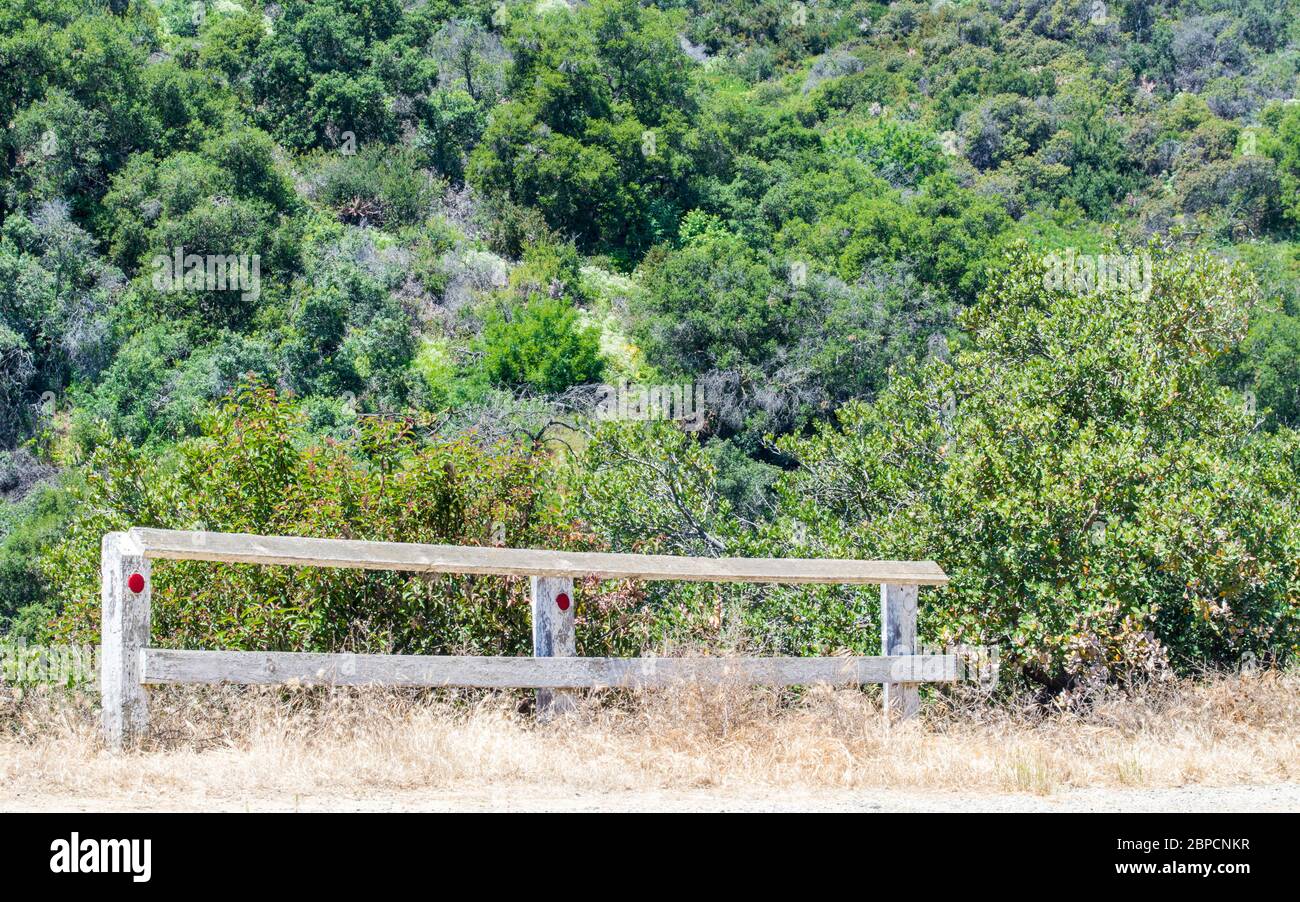 an abandoned wooden fence section used as a dead end road barrier on a ...