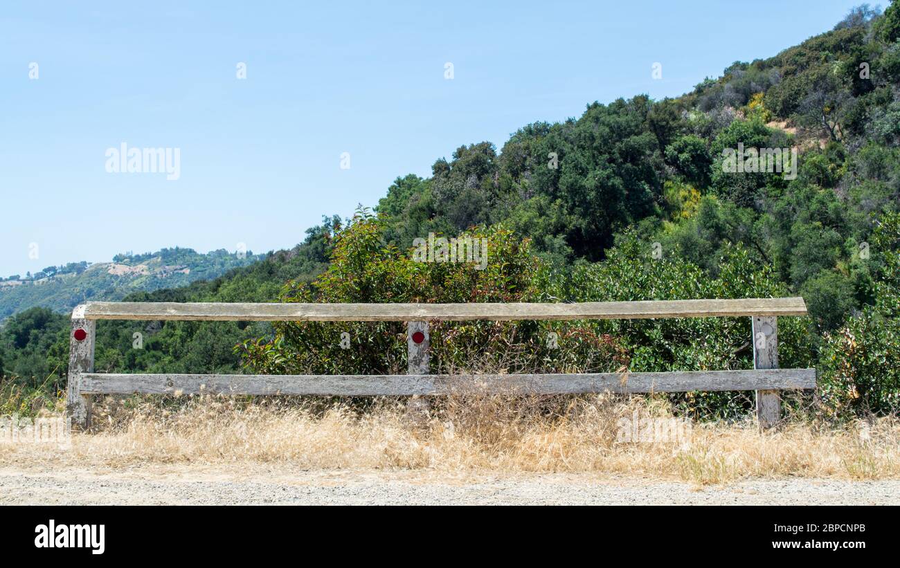 an abandoned wooden fence section used as a dead end road barrier on a ...