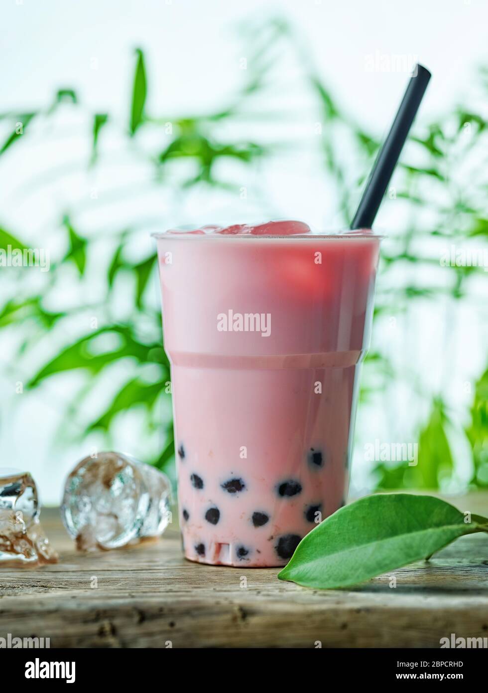 plastic cup of iced bubble tea on wooden table Stock Photo - Alamy