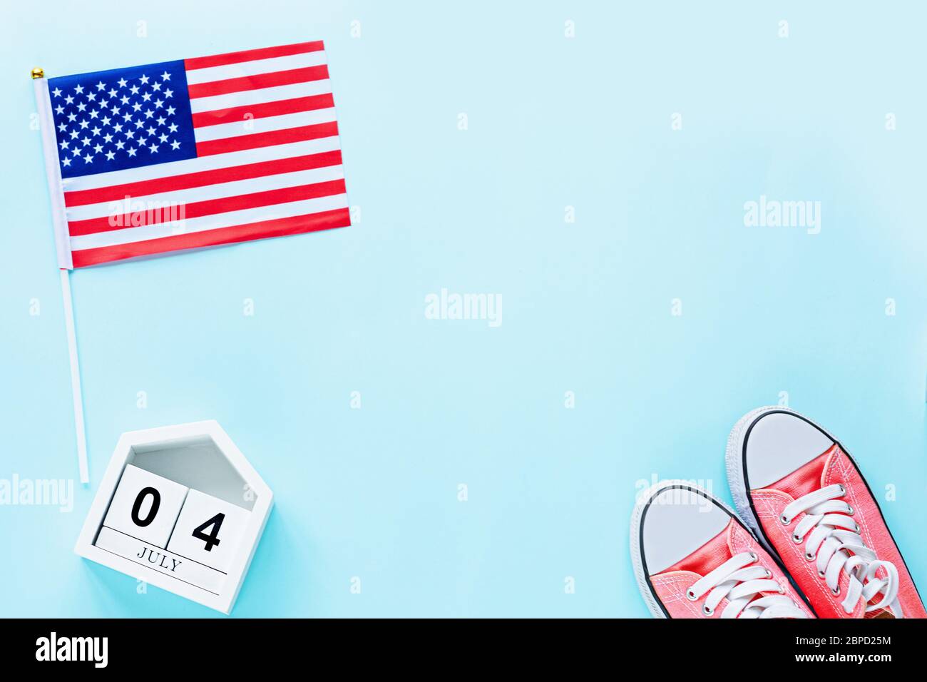 July 4th. Mockup of july 4 wooden color calendar and USA flag on blue ...