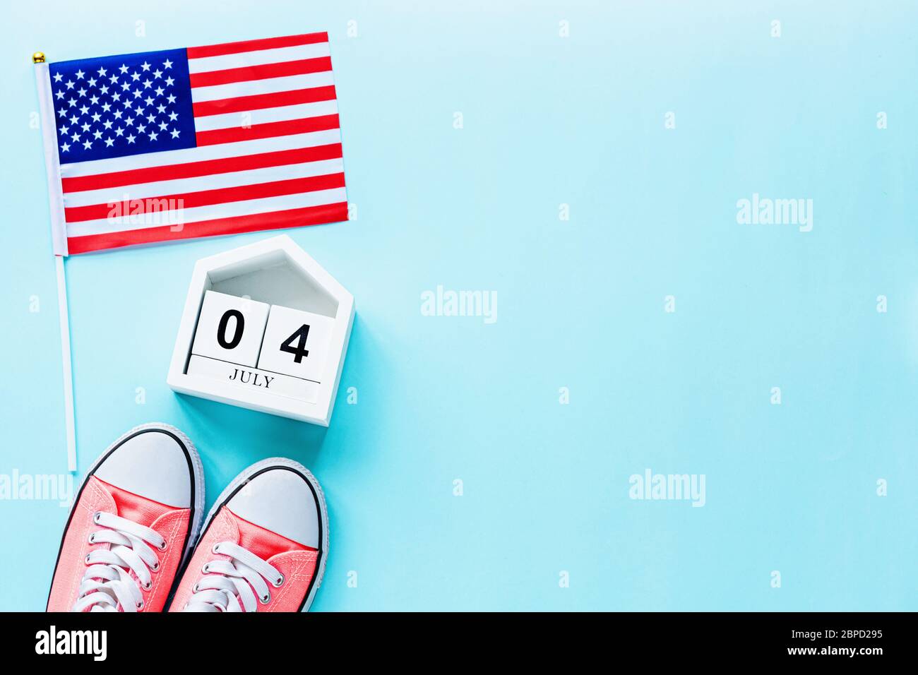 July 4th. Mockup of july 4 wooden color calendar and USA flag on blue ...