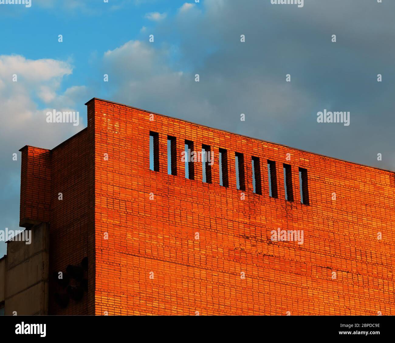 Brick building with dramatic gaps architecture background Stock Photo ...