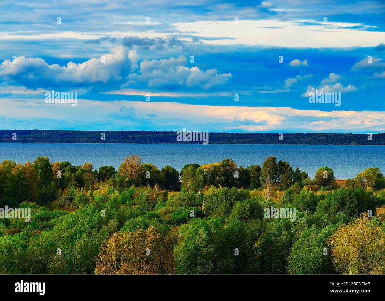 Vast river surrounded by forests landscape background Stock Photo - Alamy