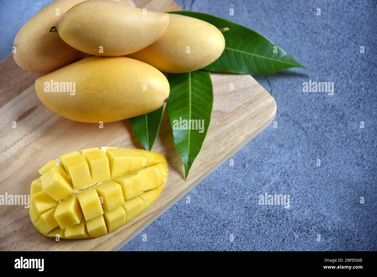 Tropical Fruits. Fresh and beautiful mango fruit set in a wooden with ...