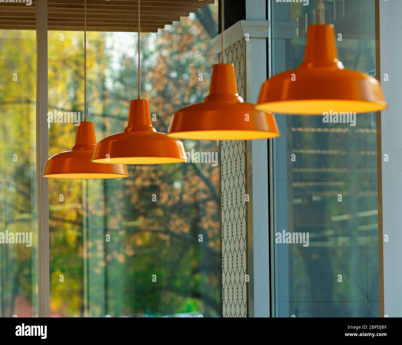 Multiple orange lamps interior background Stock Photo - Alamy