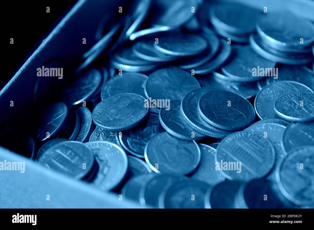 Paper box with a bunch of American cents close up. Money background ...