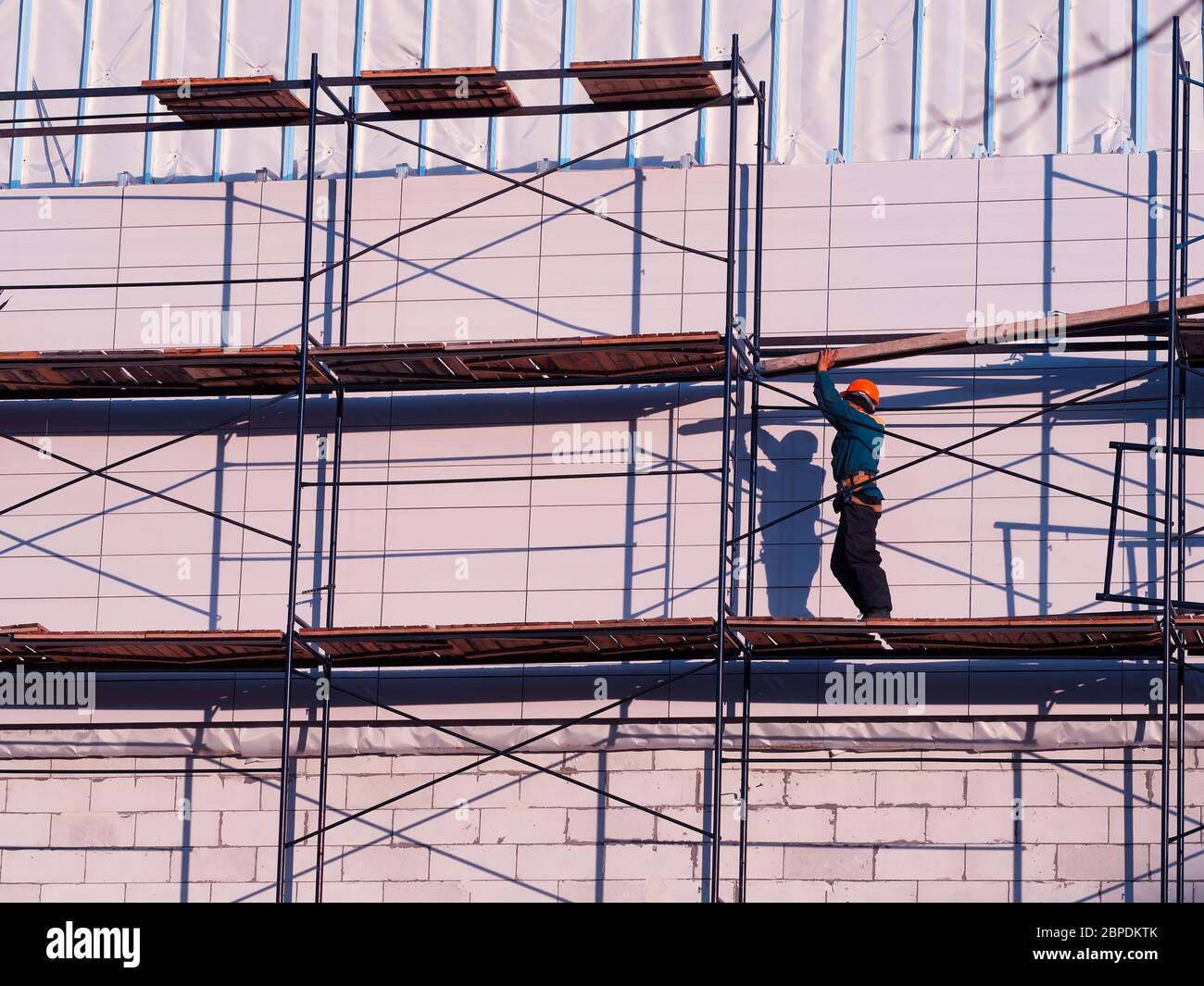 Worker constructing wooden scaffold background Stock Photo - Alamy