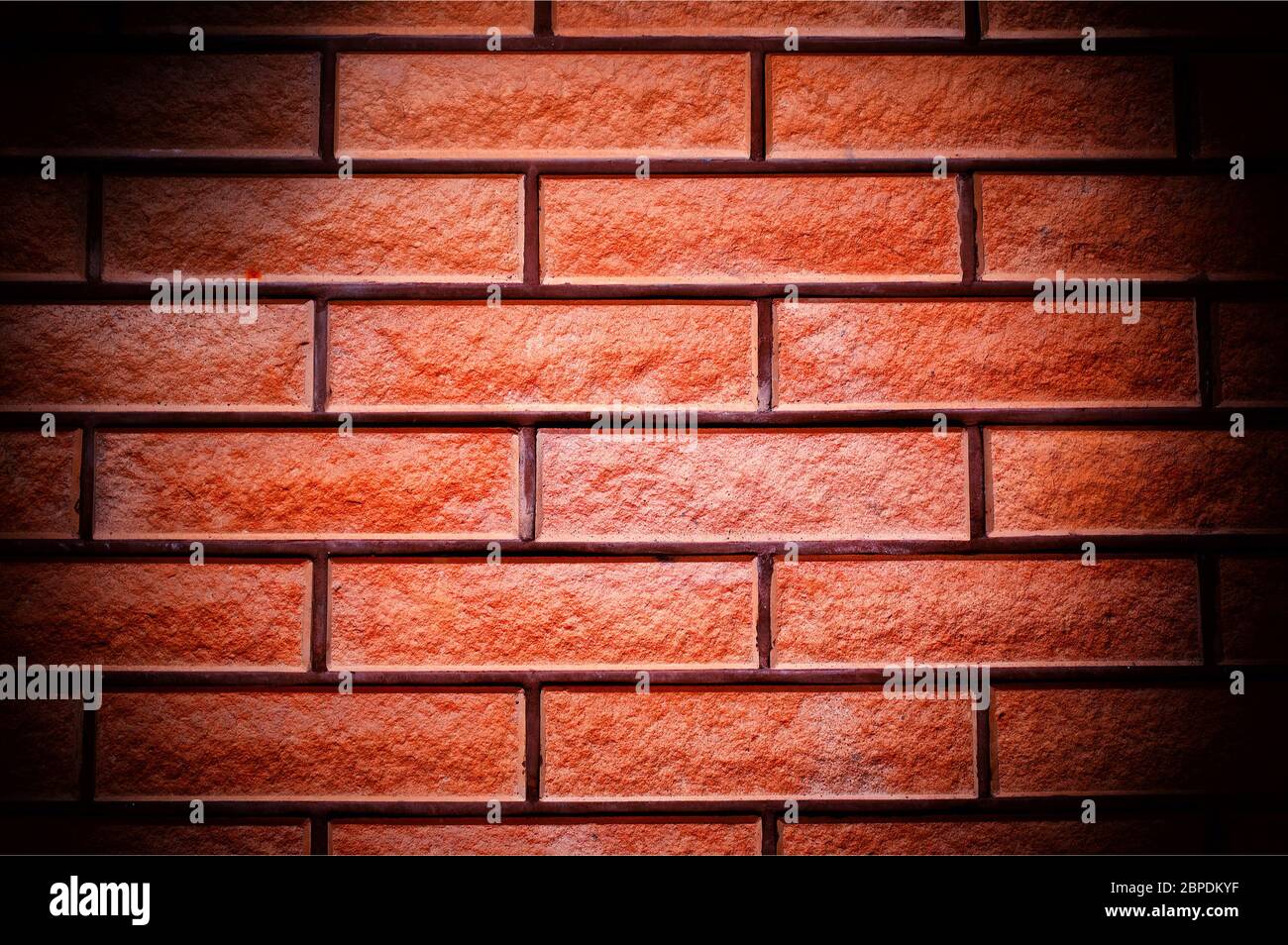 Vibrant red brick street wall texture background Stock Photo - Alamy