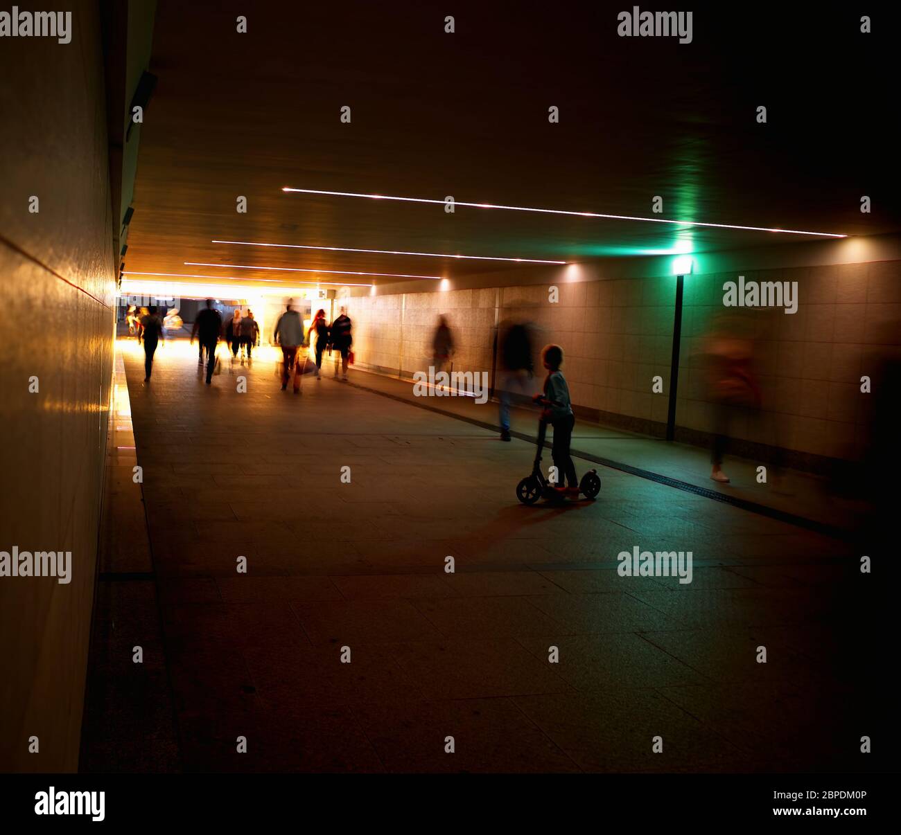 Girl riding modern electrical scooter in night city passage Stock Photo ...